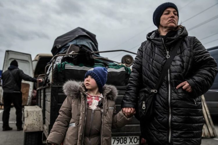 A woman and her daughter arrive at a refugee center in the southeastern ...